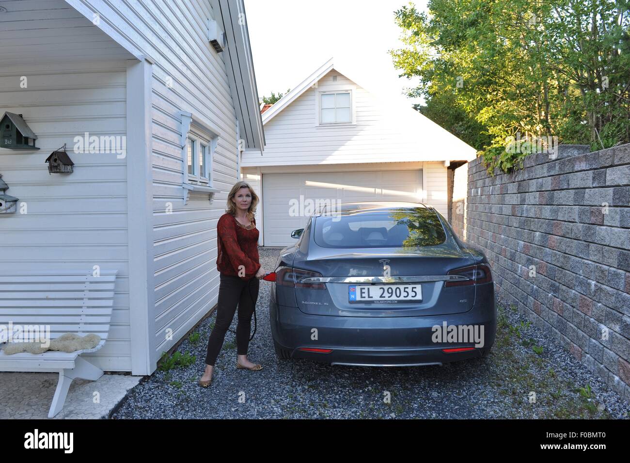 Son, Norway. 03rd Aug, 2015. Nina Haug Eide charges her Tesla electric ...