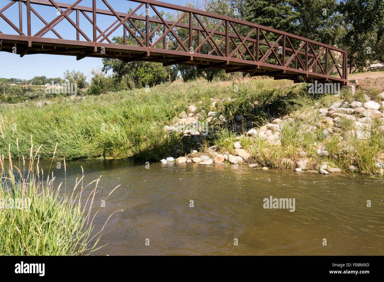 A walking bridge over the creek in Kin Coulee Park at Medicine Hat ...