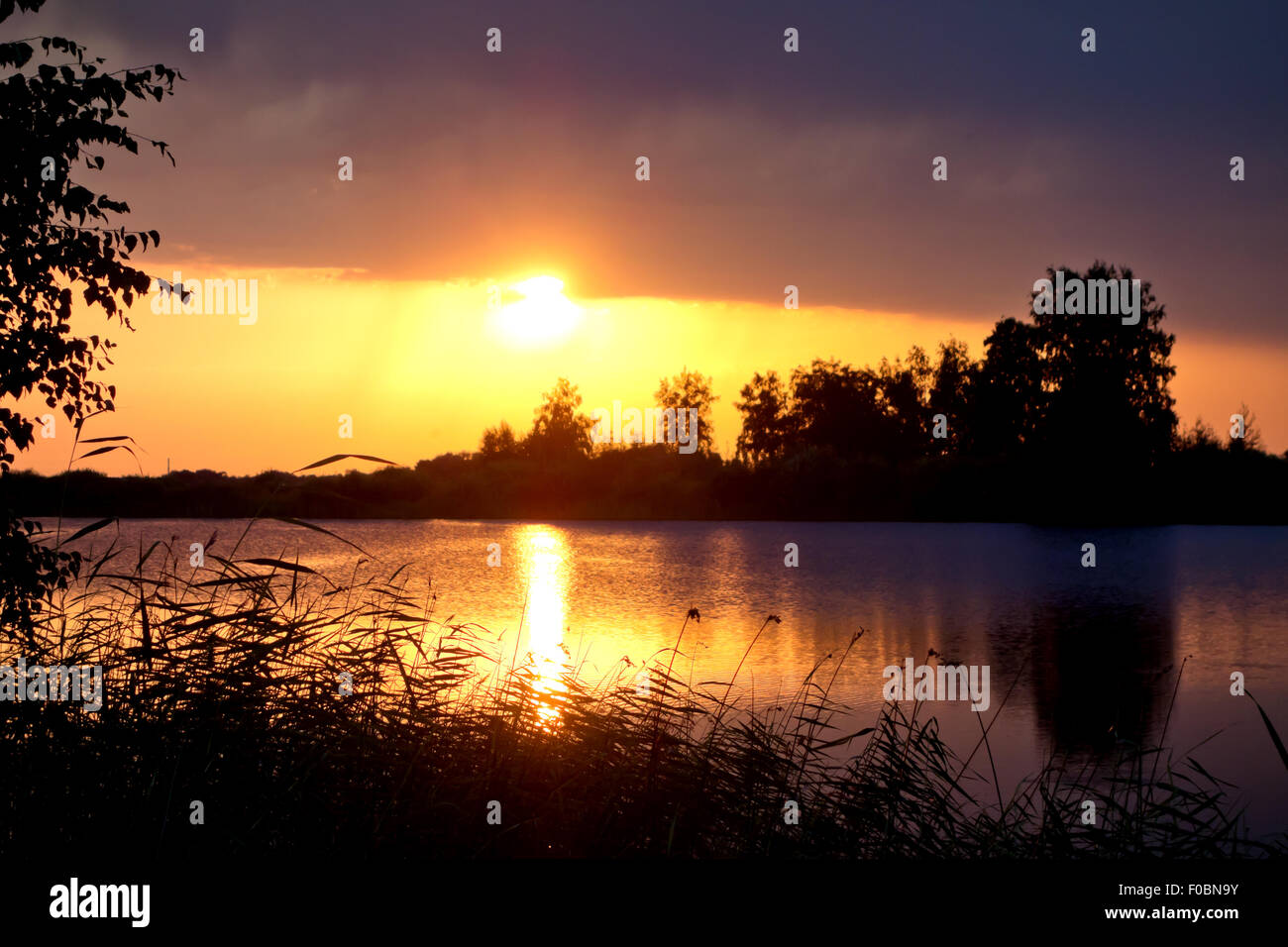 red sunset over lake Stock Photo - Alamy