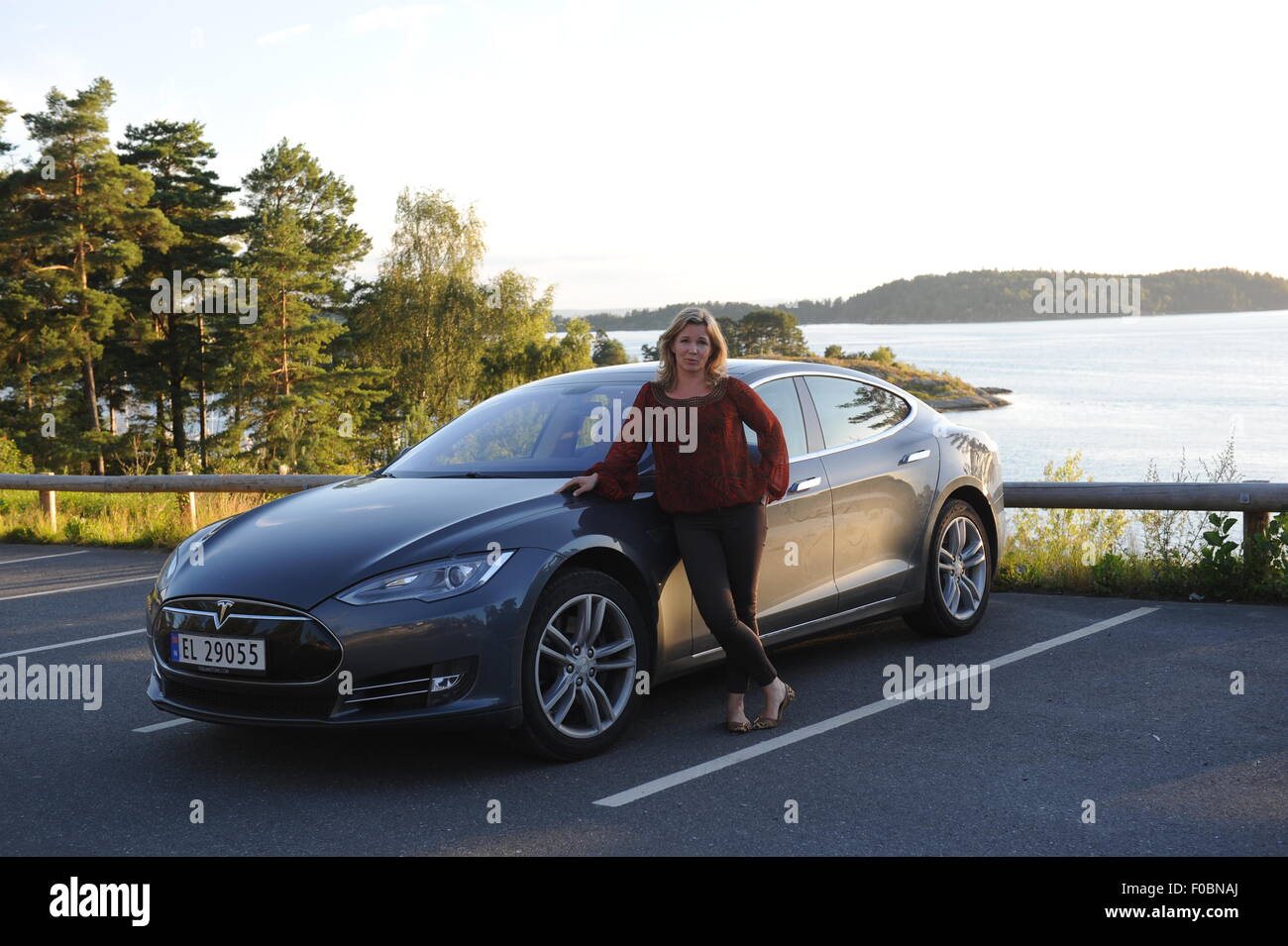 Oslo, Norway. 03rd Aug, 2015. Nina Haug Eide stands next to her Tesla ...