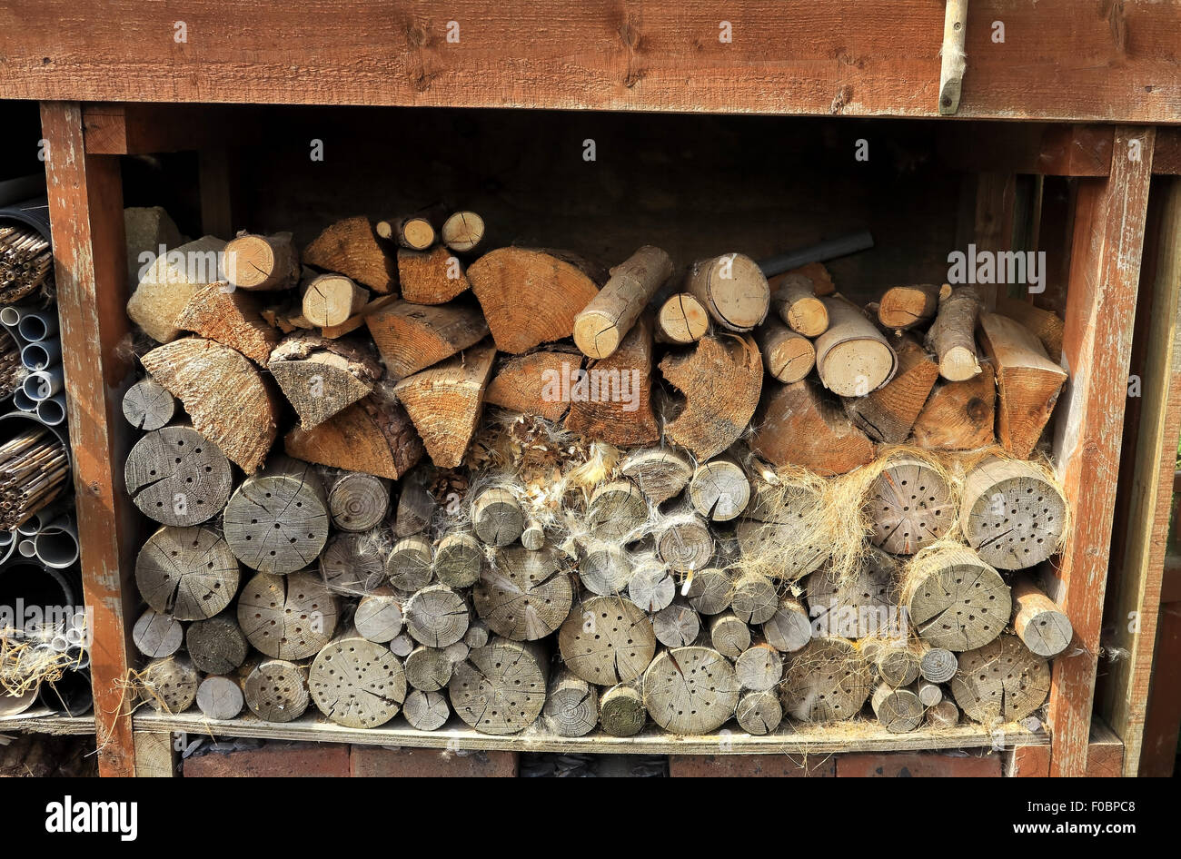 A wooden frame with logs in which give bugs and insects a place to ...