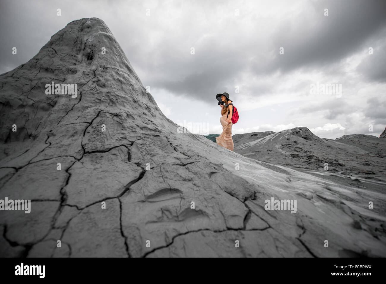 Female traveler walking near mud volcanoes Stock Photo - Alamy
