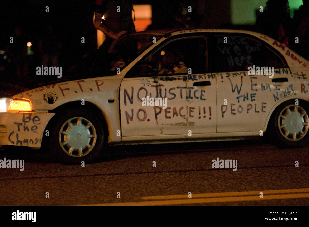Ferguson, USA. 11th Aug, 2015. A car painted with slogans is seen ...