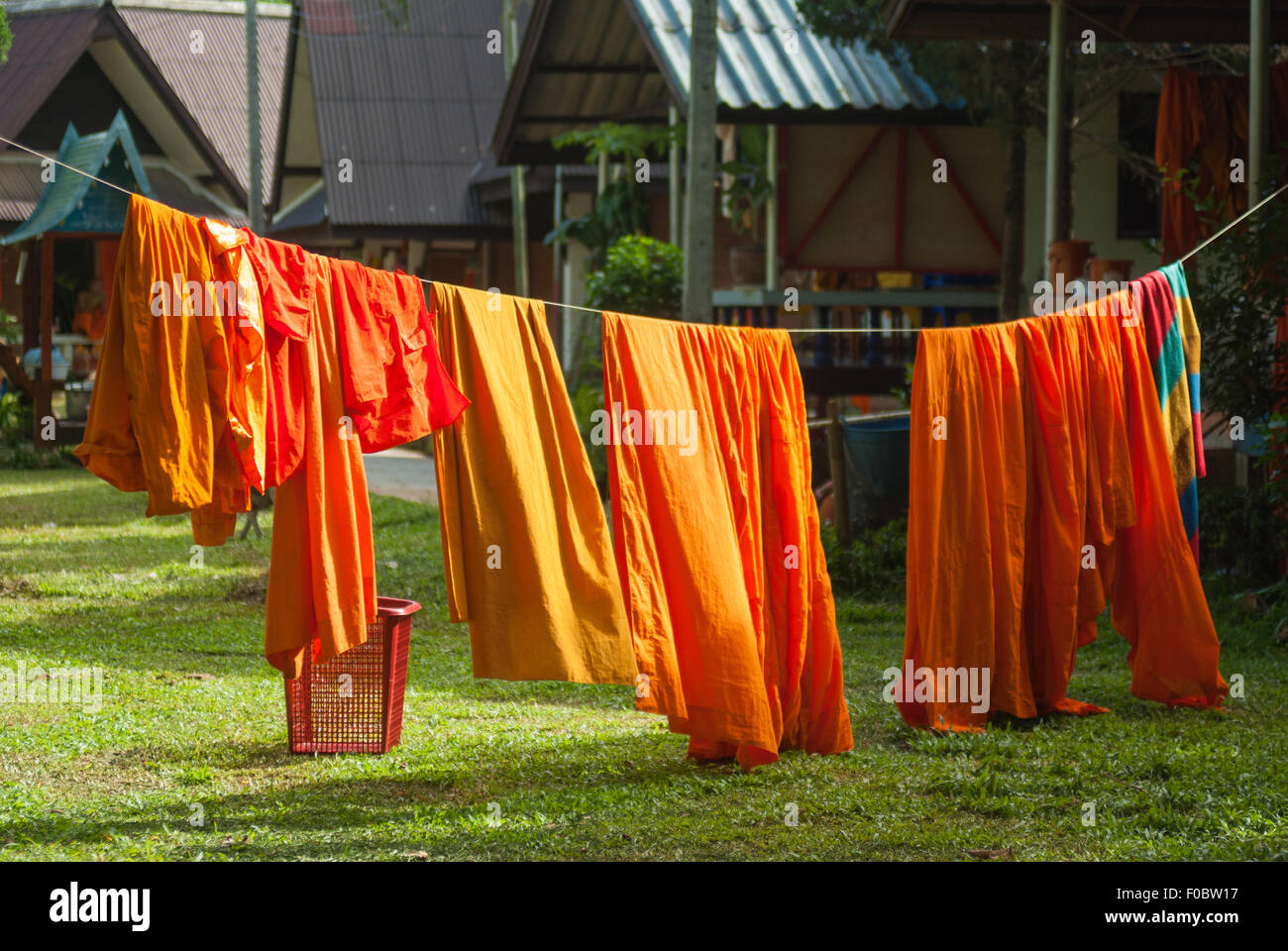 Orange monk clothes at sun, Thailand Stock Photo - Alamy
