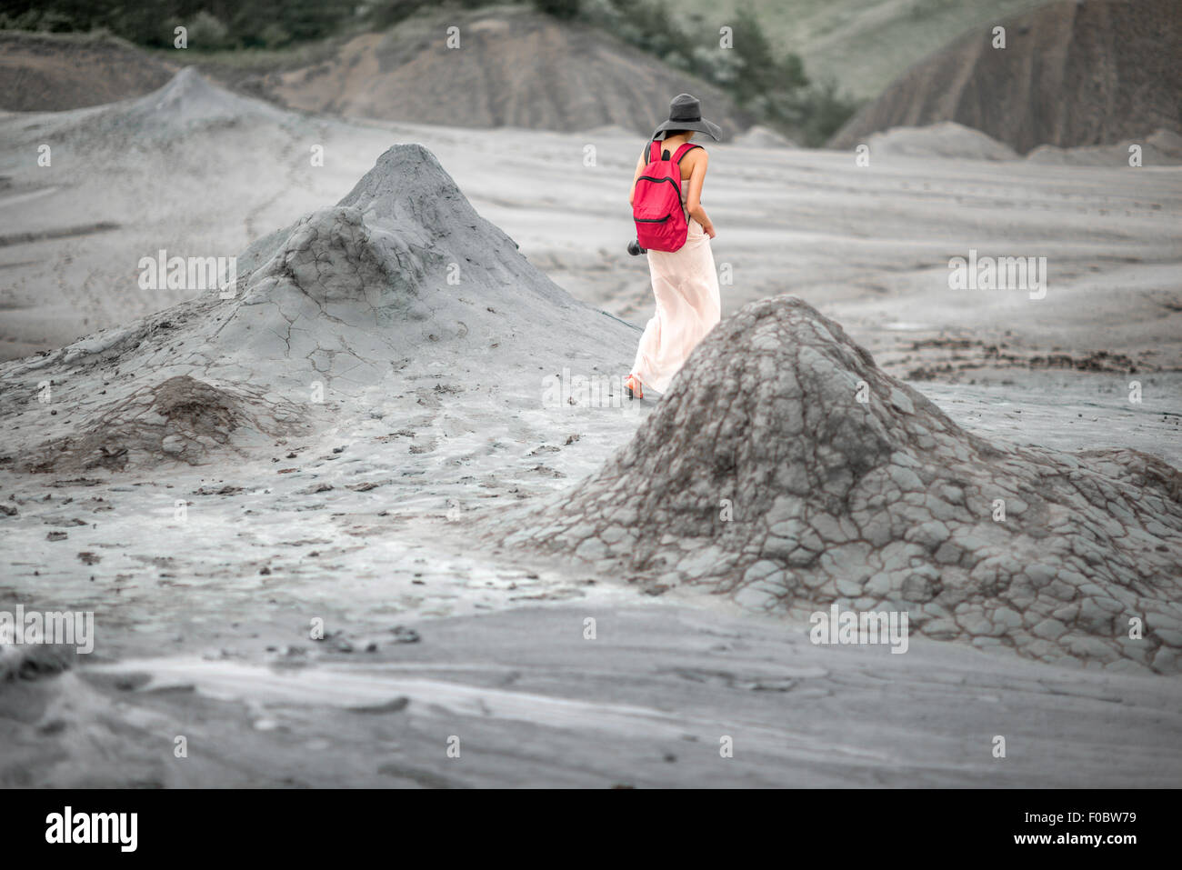Female traveler walking near mud volcanoes Stock Photo - Alamy