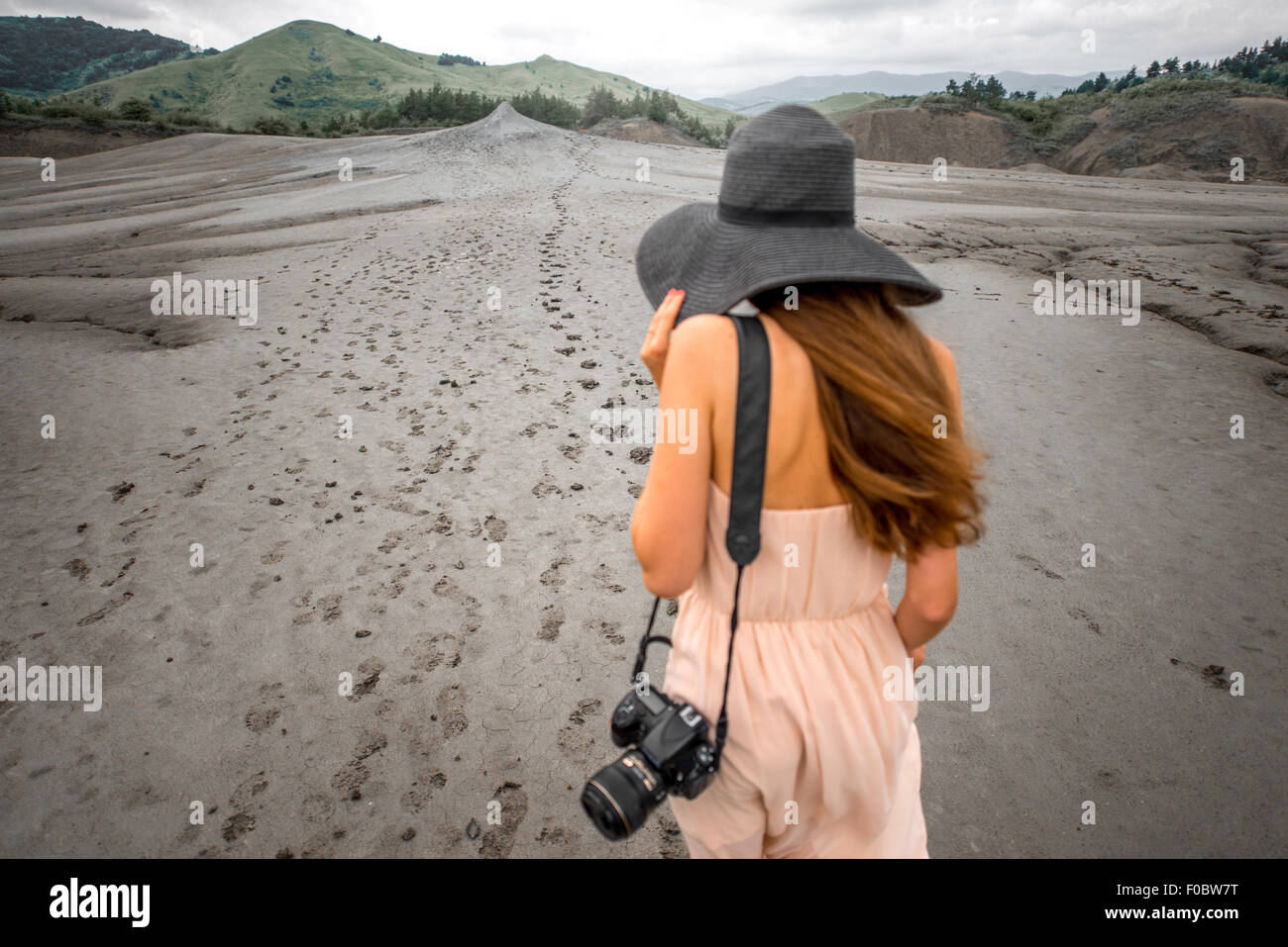 Female traveler walking near mud volcanoes Stock Photo - Alamy