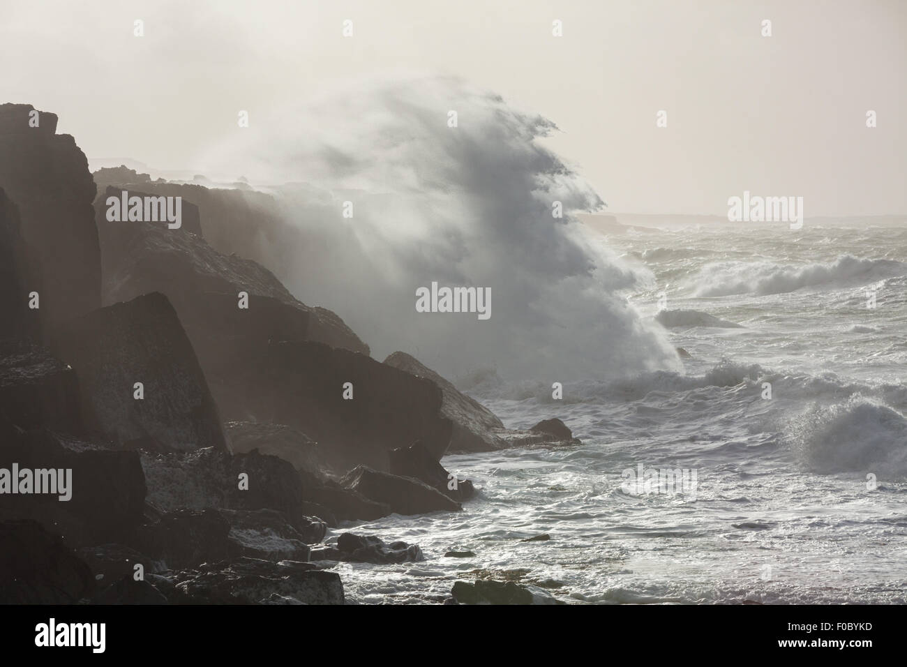 Big waves breaking on cliffs during winter storm on the west coast of ...