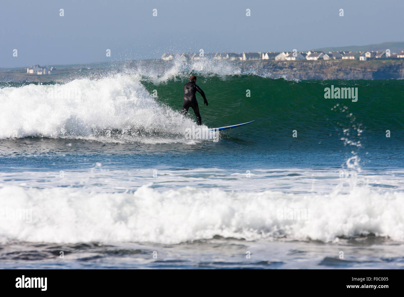 Surfing the Waves off Lahinch beach, Ireland Stock Photo - Alamy