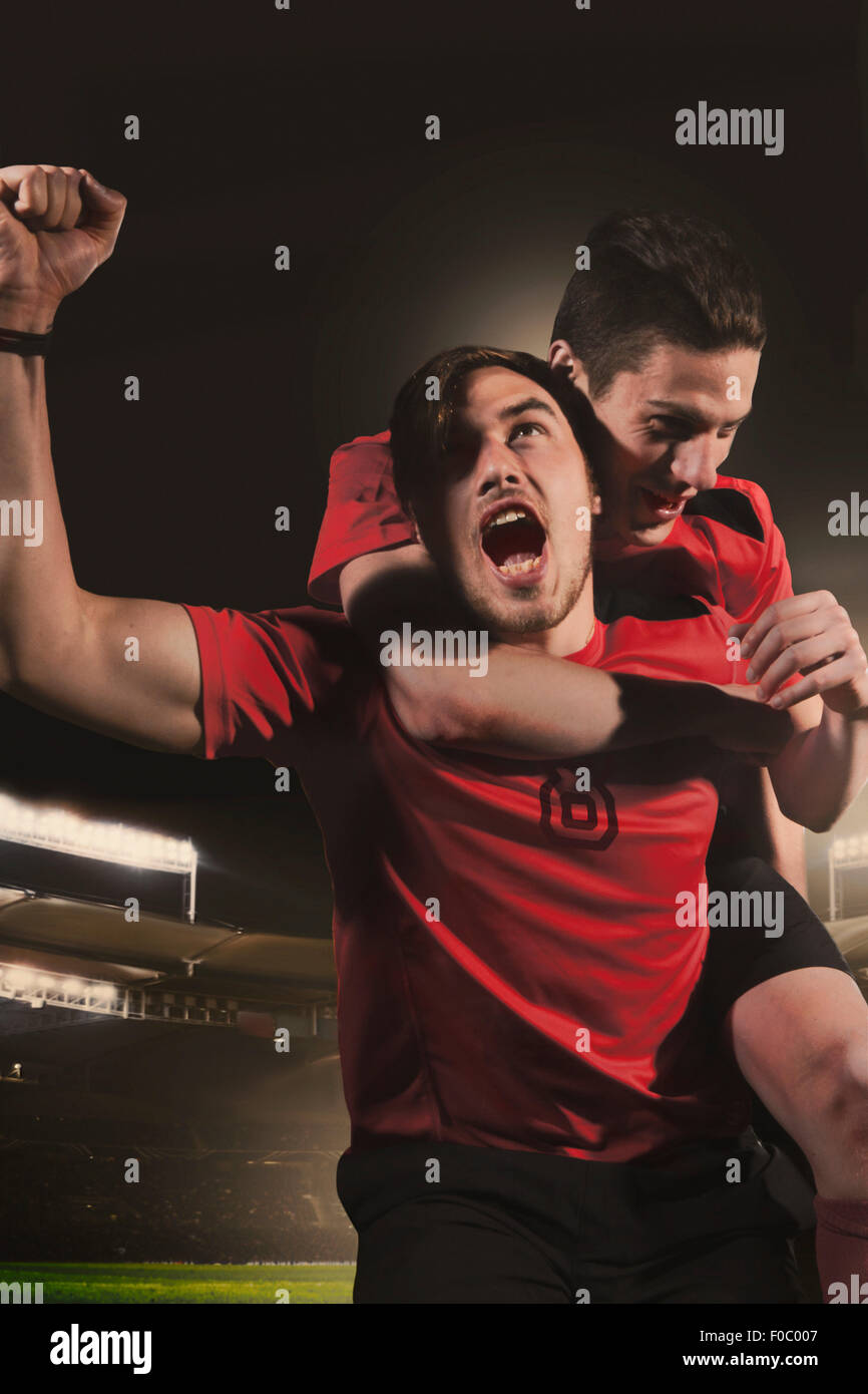 Male soccer players celebrating victory in stadium Stock Photo - Alamy