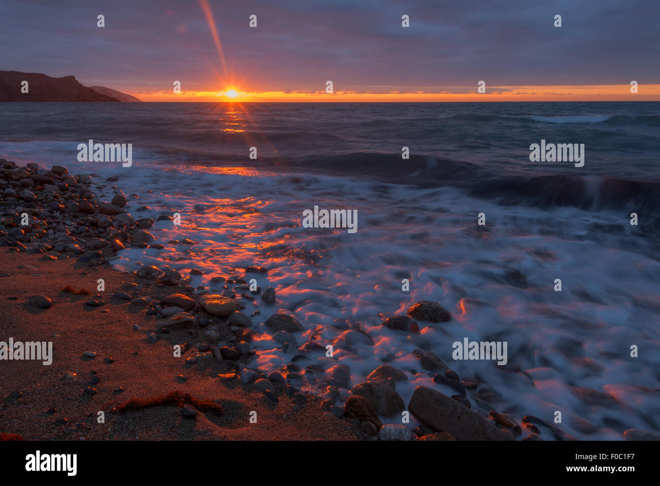 Sea beach on sunset time Stock Photo - Alamy