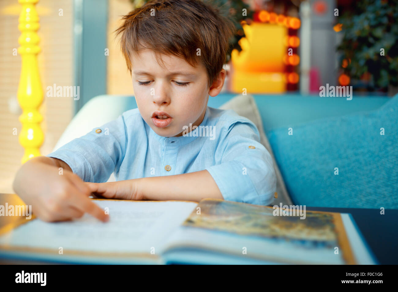 Preschooler boy reading book Stock Photo - Alamy