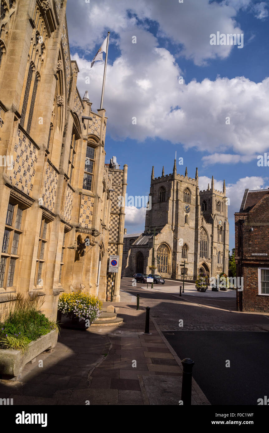 View of Lynn Minster & Jacobean diaperwork facade of Trinity Guildhall ...