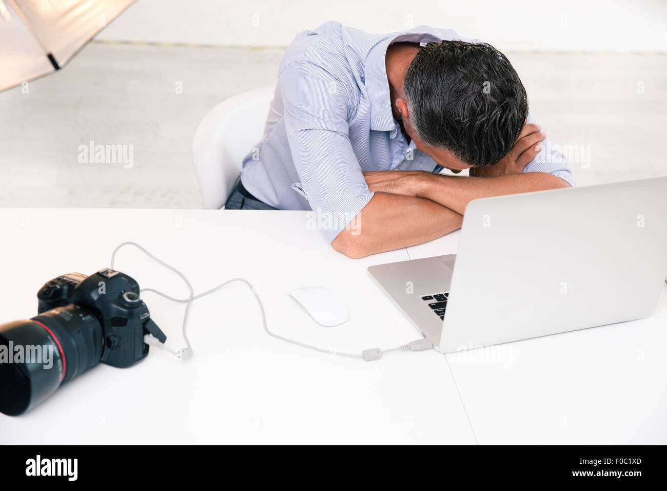 Photographer sleeping at his workplace in studio Stock Photo - Alamy