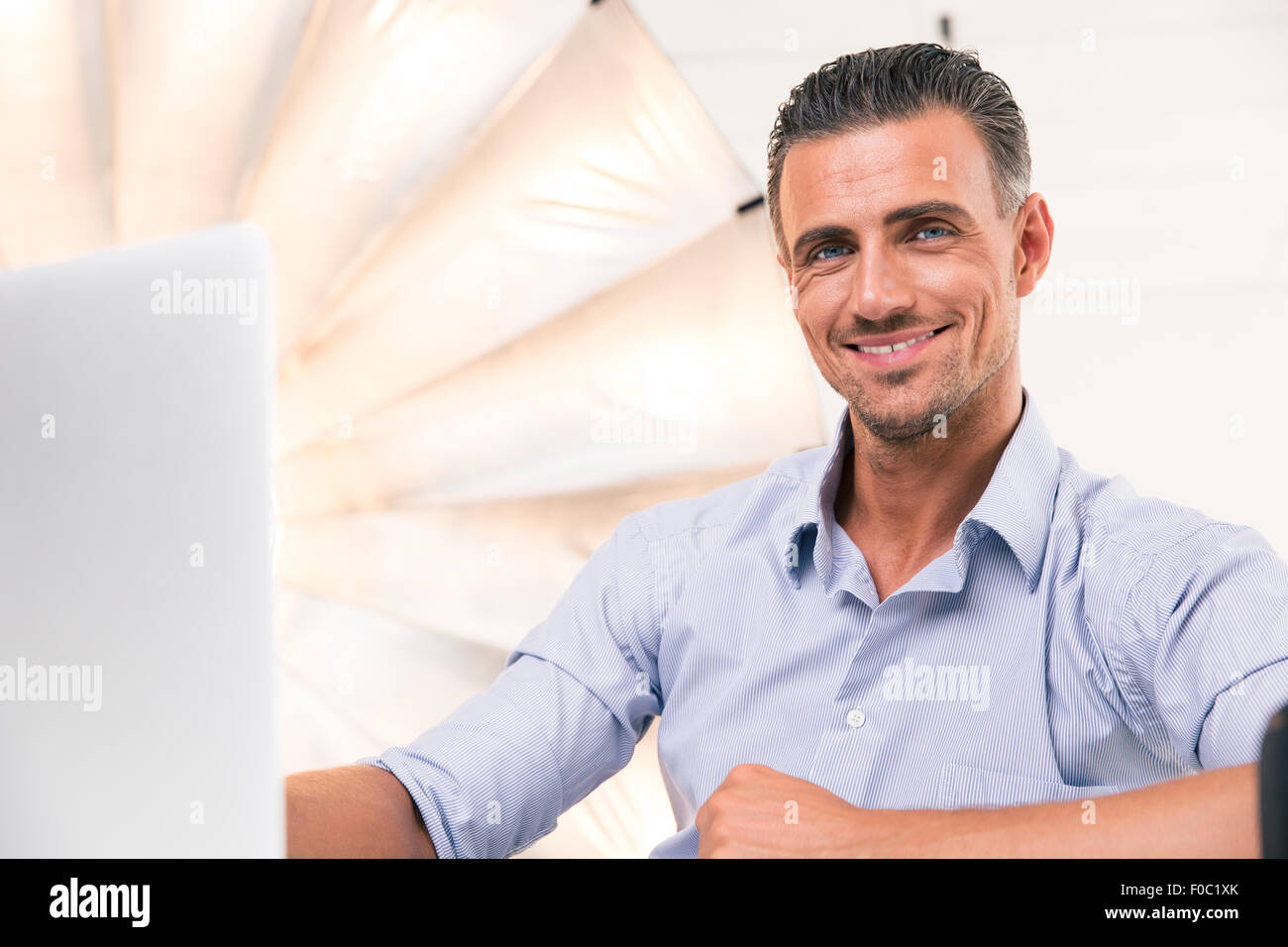 Looking at camera sitting smiling journalist hi-res stock photography ...
