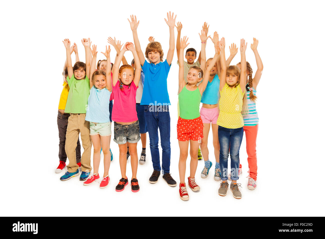 Large group of kids rise hands full height shoot Stock Photo - Alamy