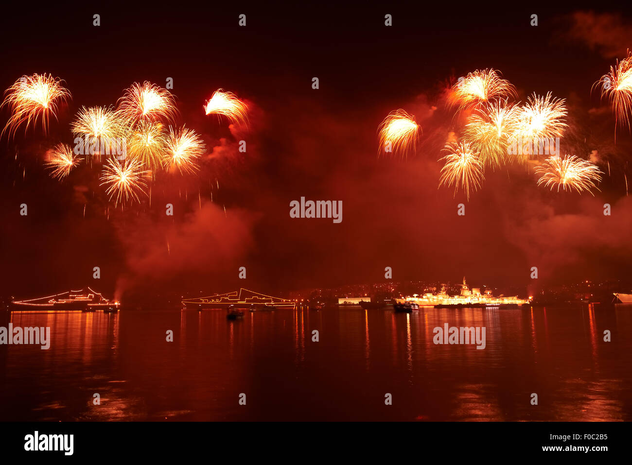 Red colorful fireworks on the black sky background Stock Photo - Alamy
