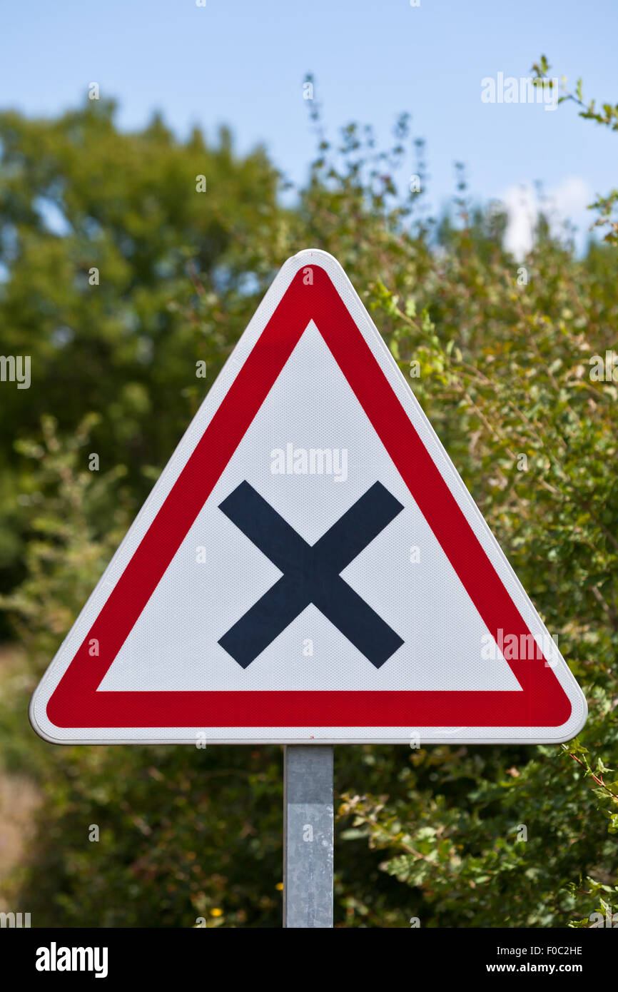 Triangular crossroads road sign on a country road junction Stock Photo ...