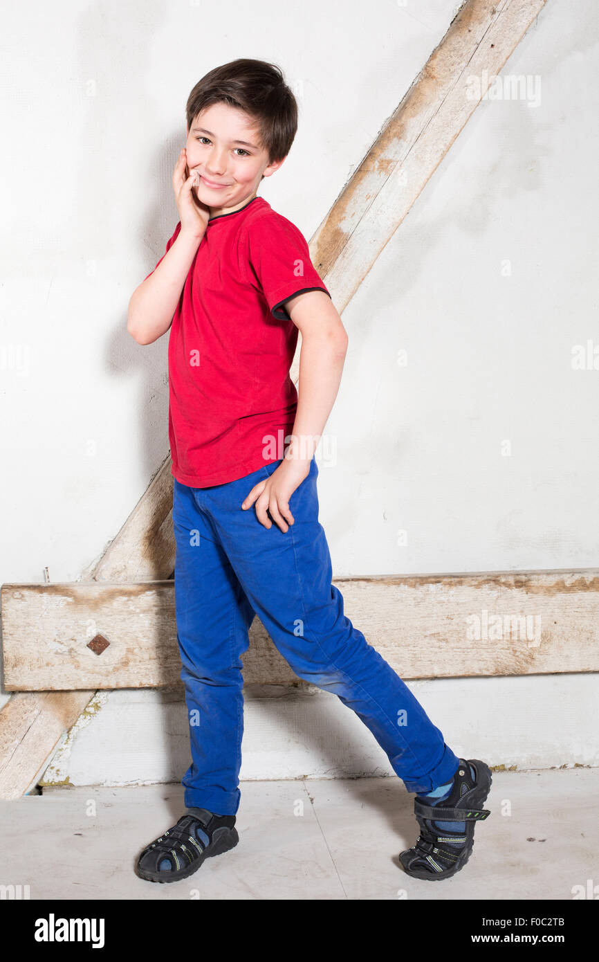 Portrait of a cute young boy standing Stock Photo - Alamy