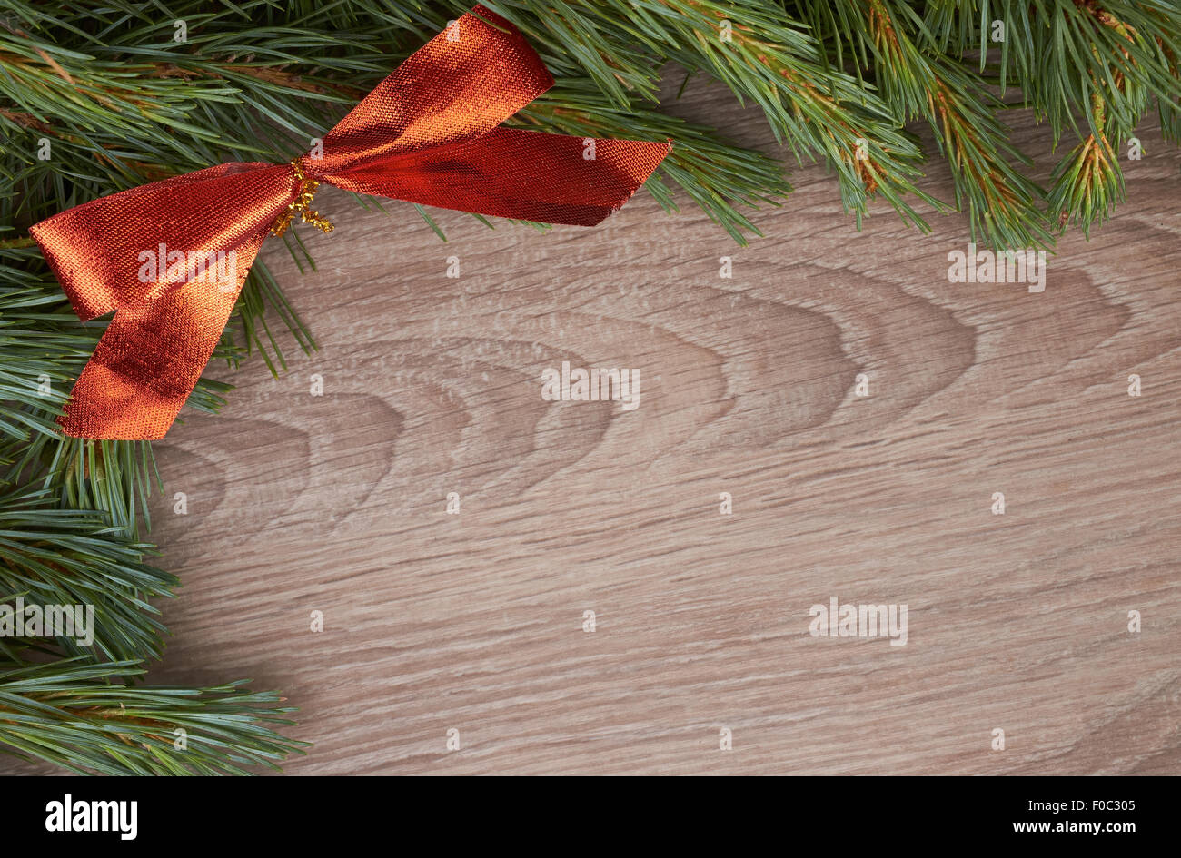 Traditional pine tree Christmas border decoration on a wood background ...