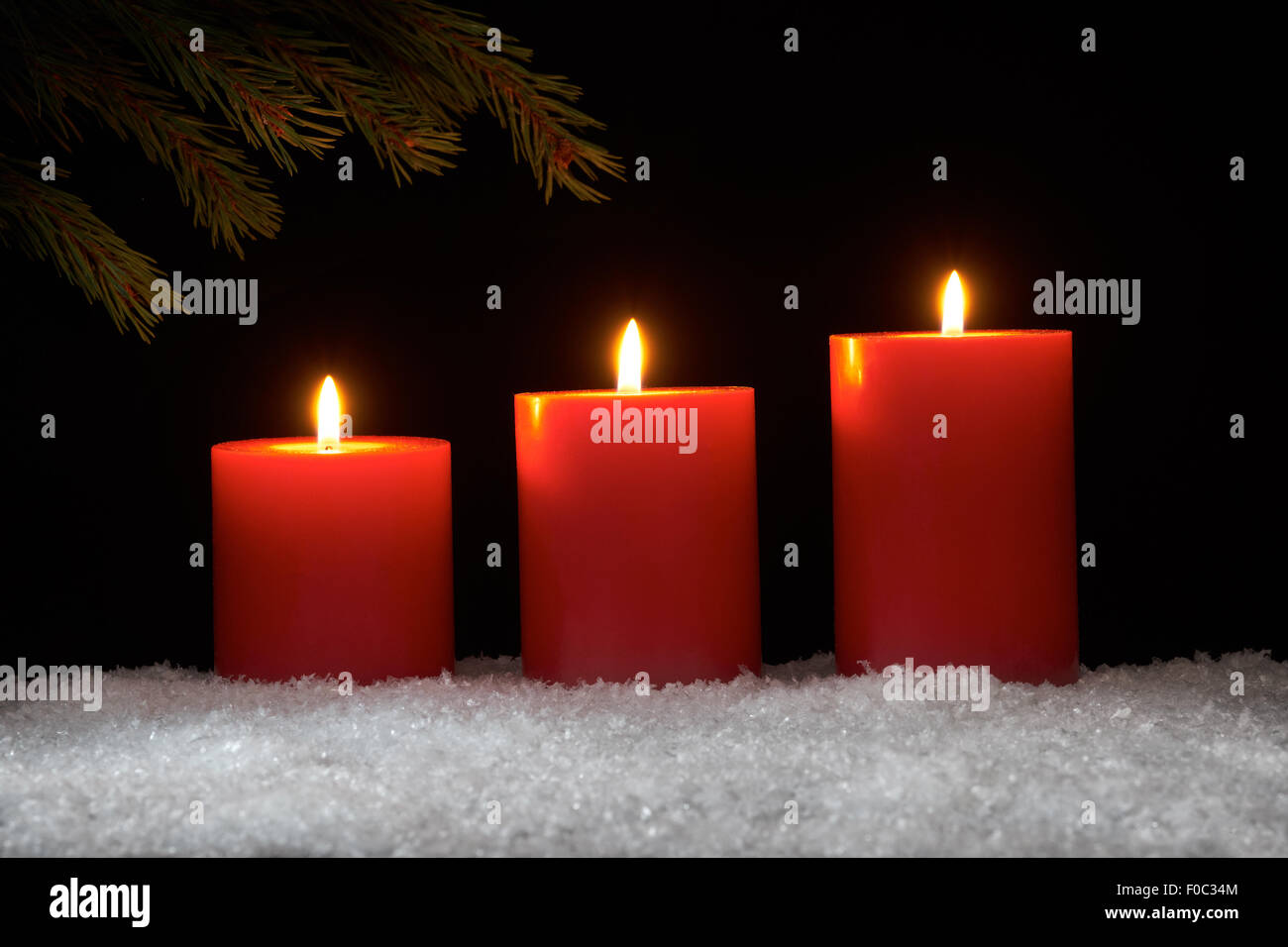 Lit red candles on a dark wooden floor with black background Stock ...