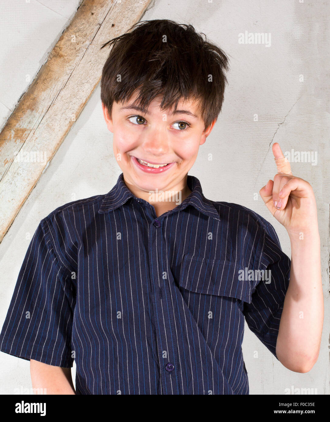portrait of a young boy pointing up a finger and smiles Stock Photo - Alamy