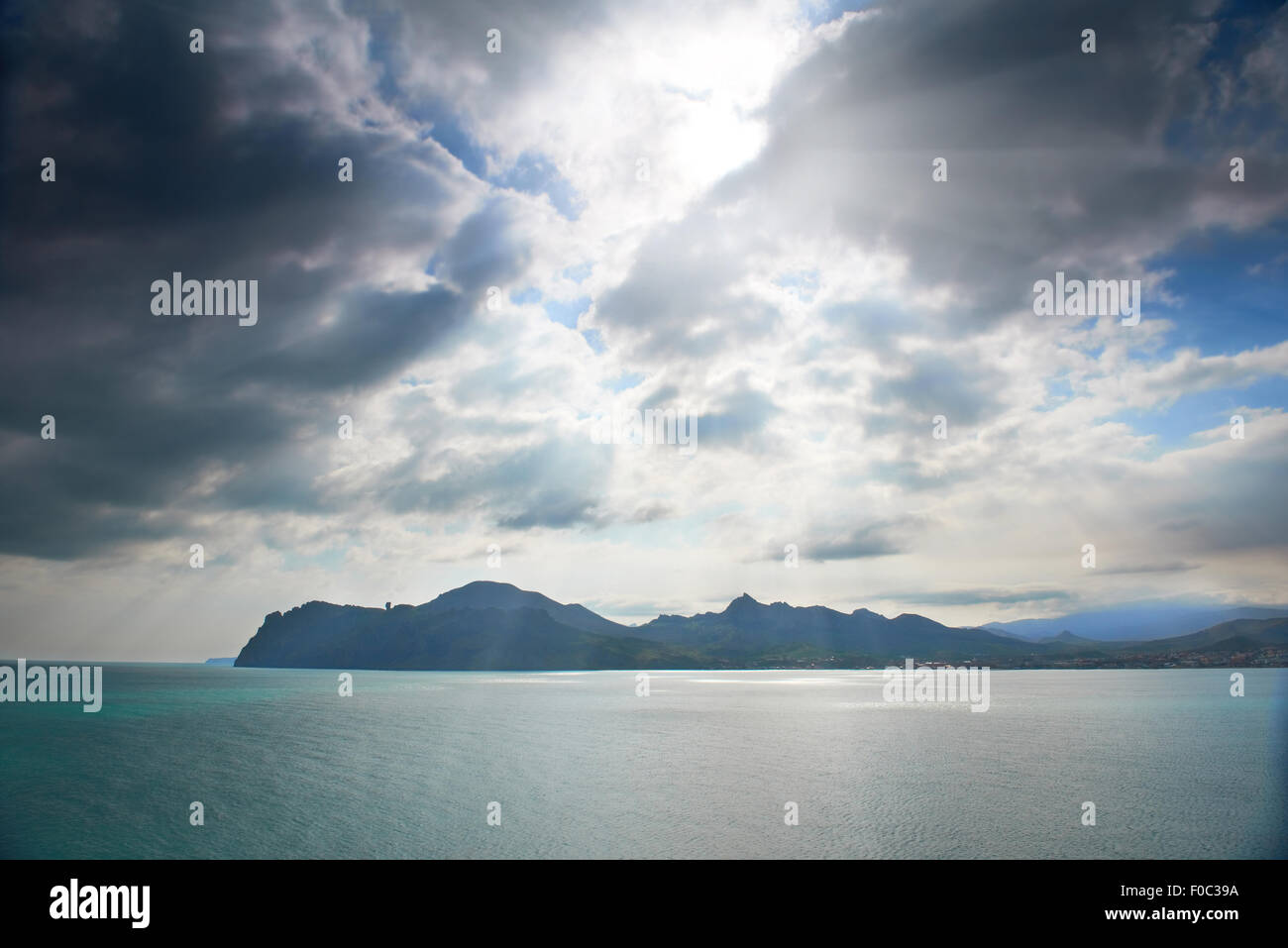 Dramatic sea with island and blue dark sky Stock Photo - Alamy