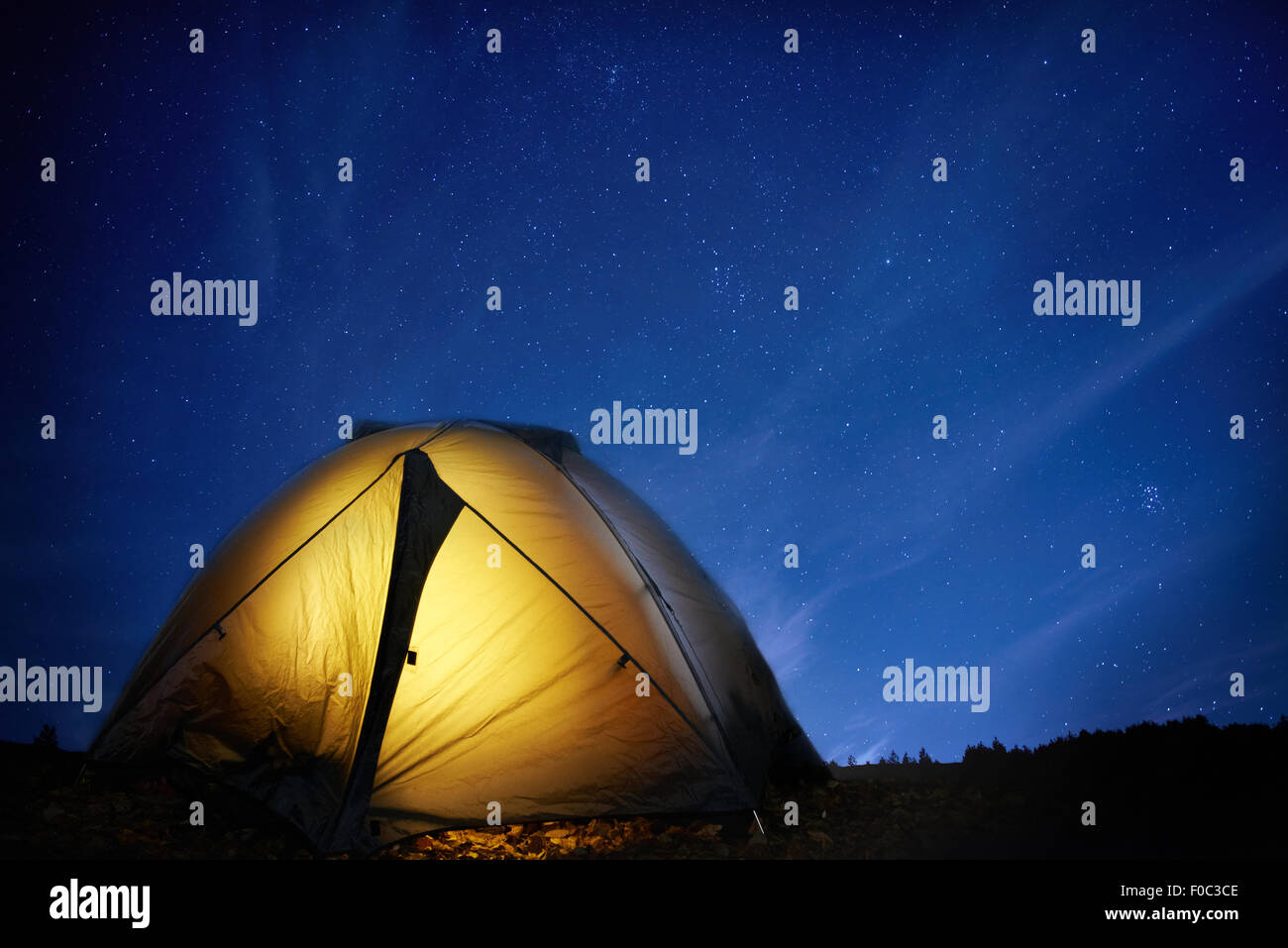 Illuminated yellow camping tent under stars at night Stock Photo - Alamy