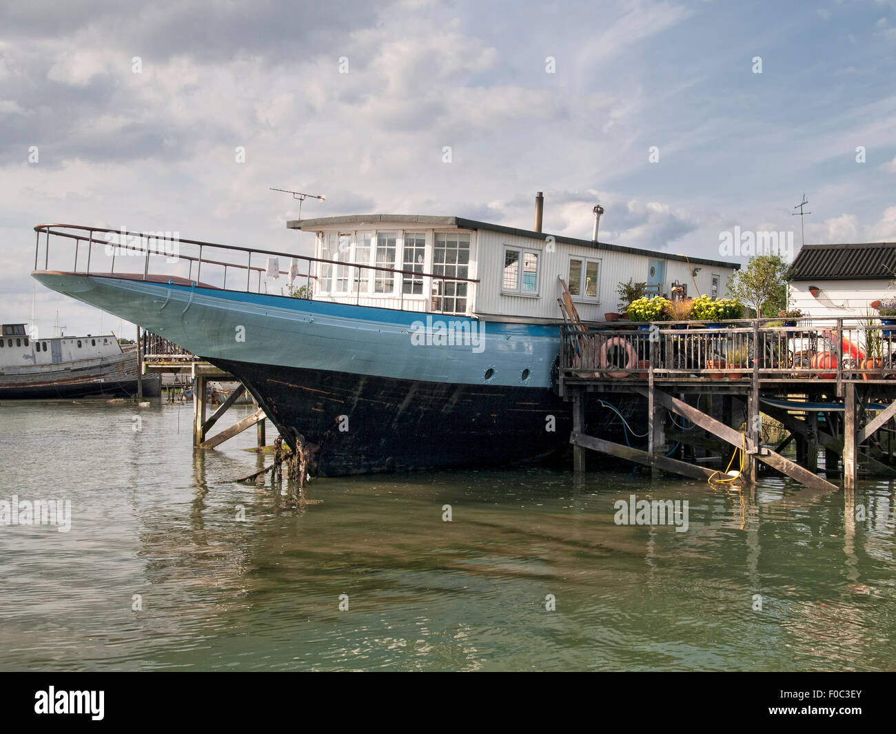 Houseboats on shoreline at West Mersea. Mersea Island. Essex. England ...