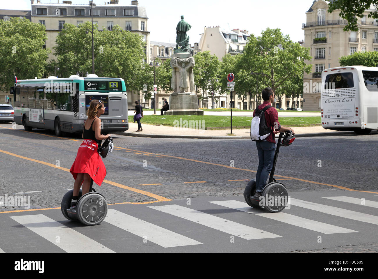 Segway crosswalk two people on segways crossing a road in Paris France ...