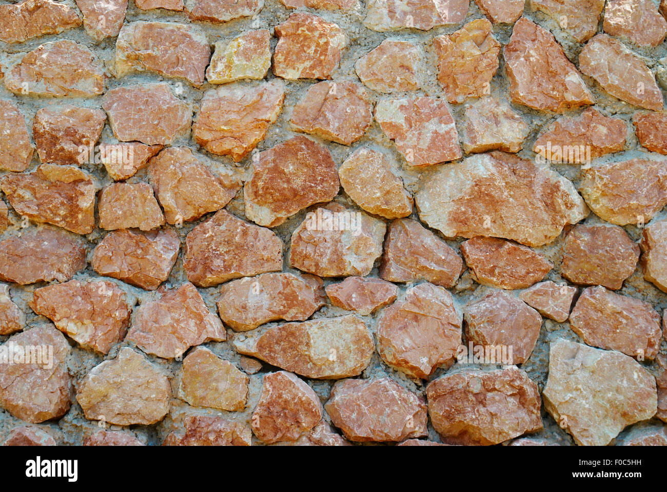 A wall of textured red stones Stock Photo - Alamy