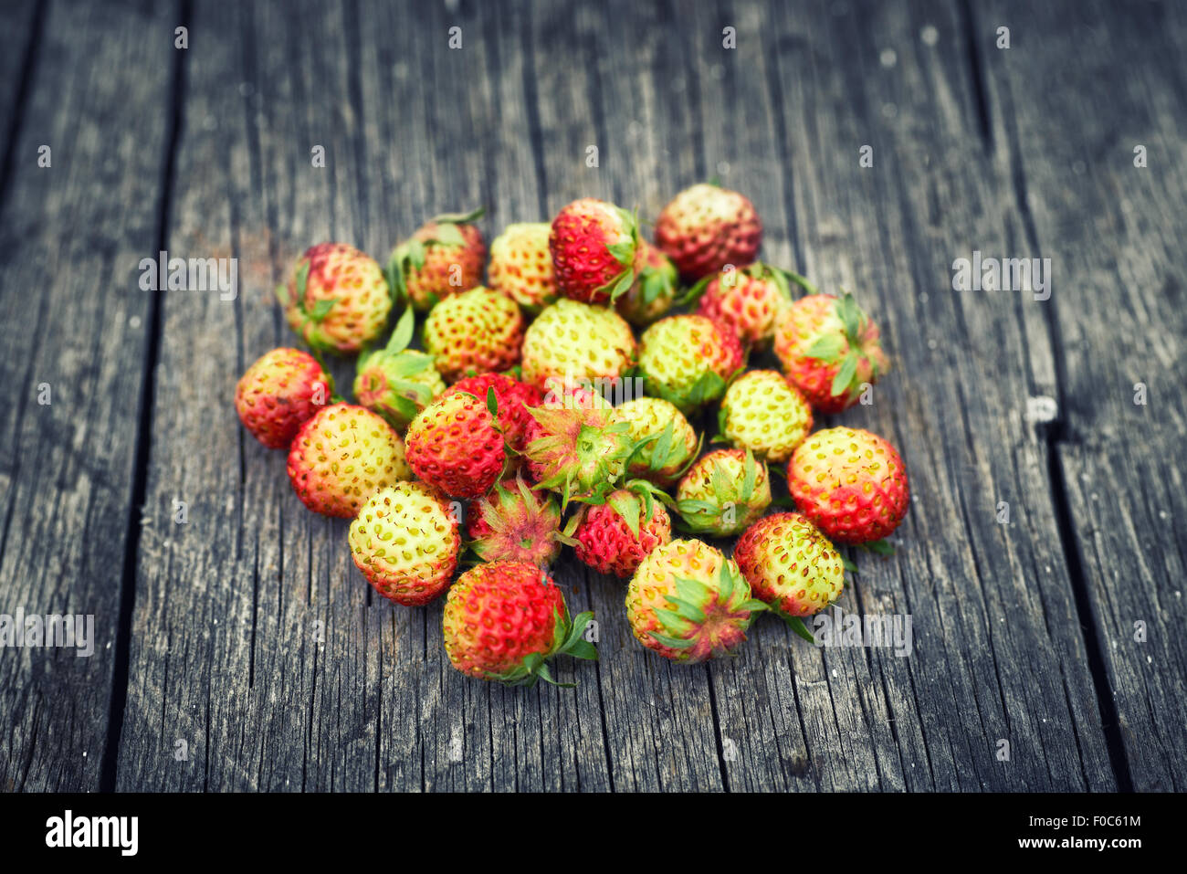 Bunch of red wild strawberry on the old wooden background Stock Photo ...