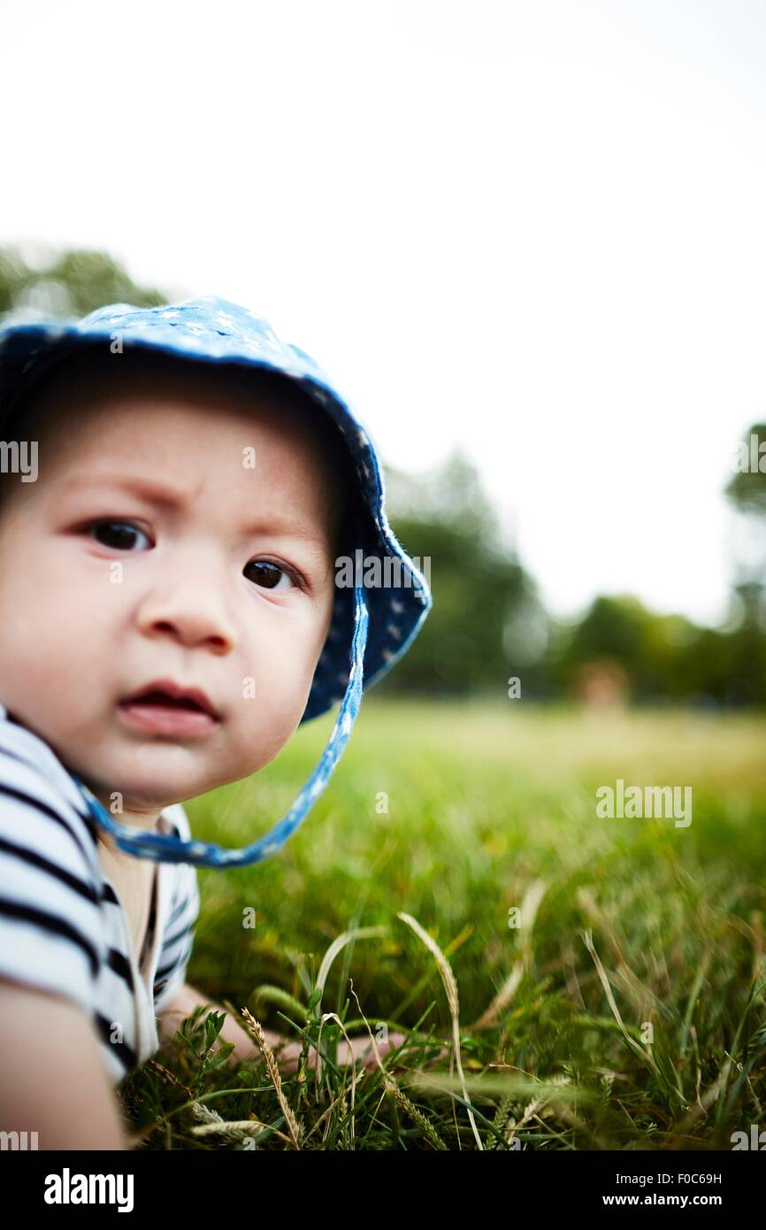 Cute baby looking into camera hat hi-res stock photography and images ...