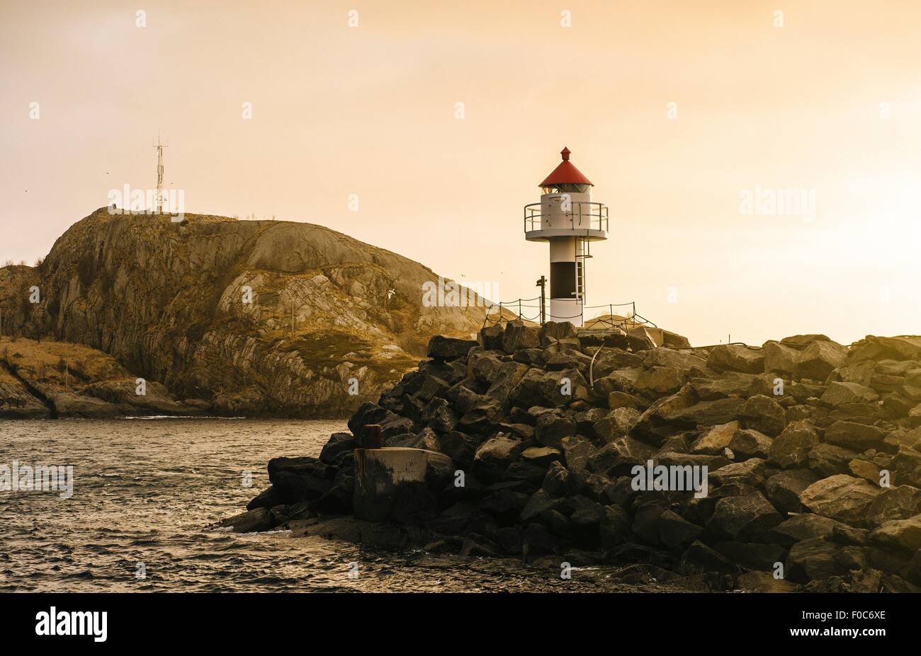 Lighthouse at harbor entrance, Reine, Lofoten, Norway Stock Photo - Alamy