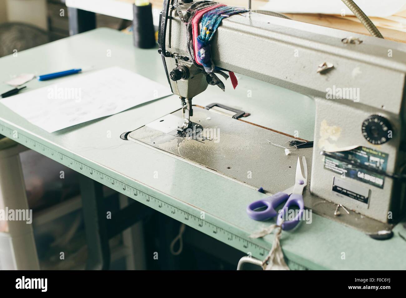 Sewing machine and scissors in fashion studio Stock Photo - Alamy