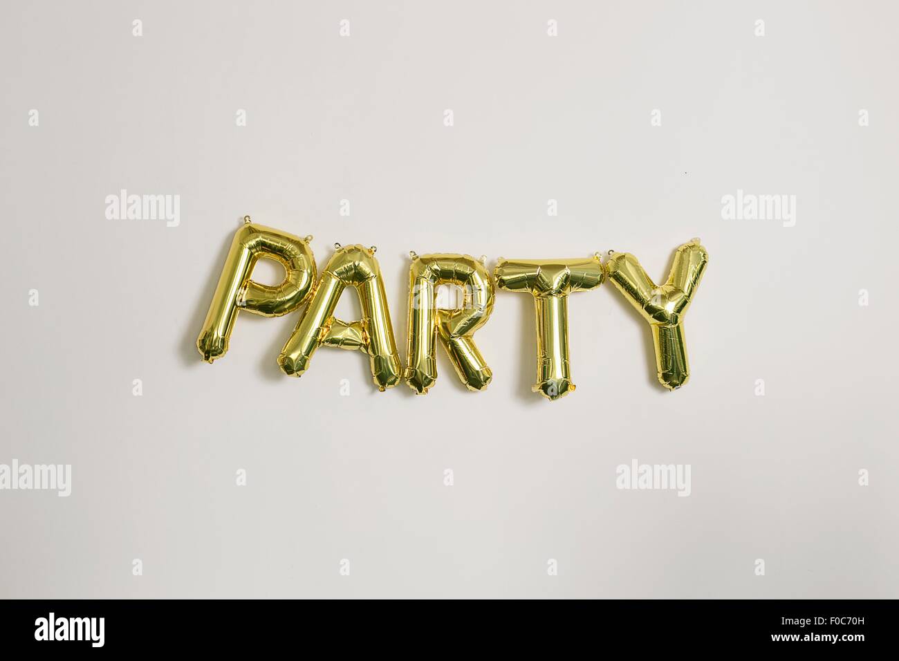 Word party in gold inflatable capital letters Stock Photo - Alamy