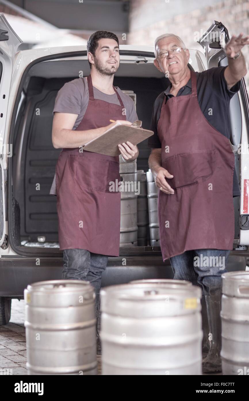 Brewers loading kegs into back of van Stock Photo - Alamy