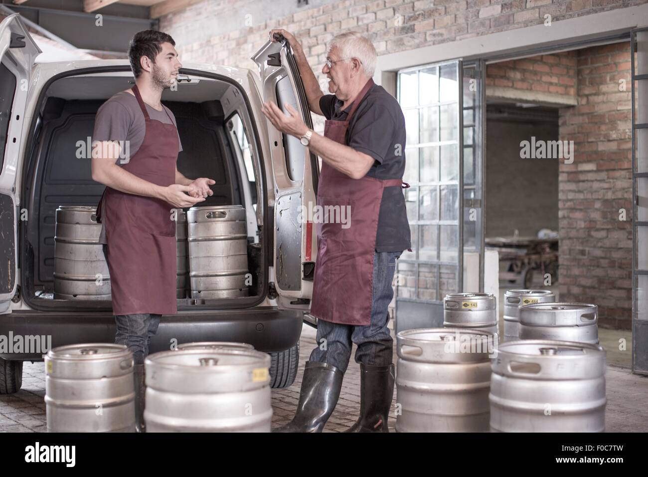 Brewers loading kegs into back of van Stock Photo - Alamy
