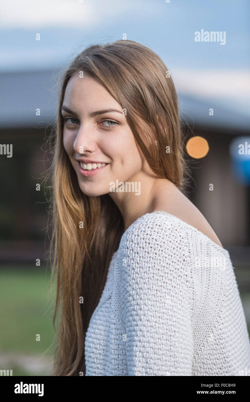 Portrait of beautiful young woman smiling outdoors Stock Photo - Alamy