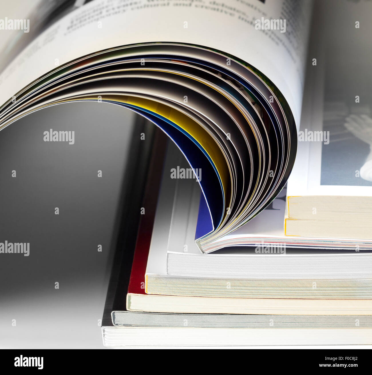 an opened book over books over gray background Stock Photo - Alamy