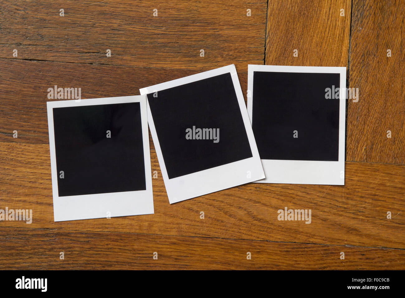 Blank photo prints on wooden table Stock Photo - Alamy