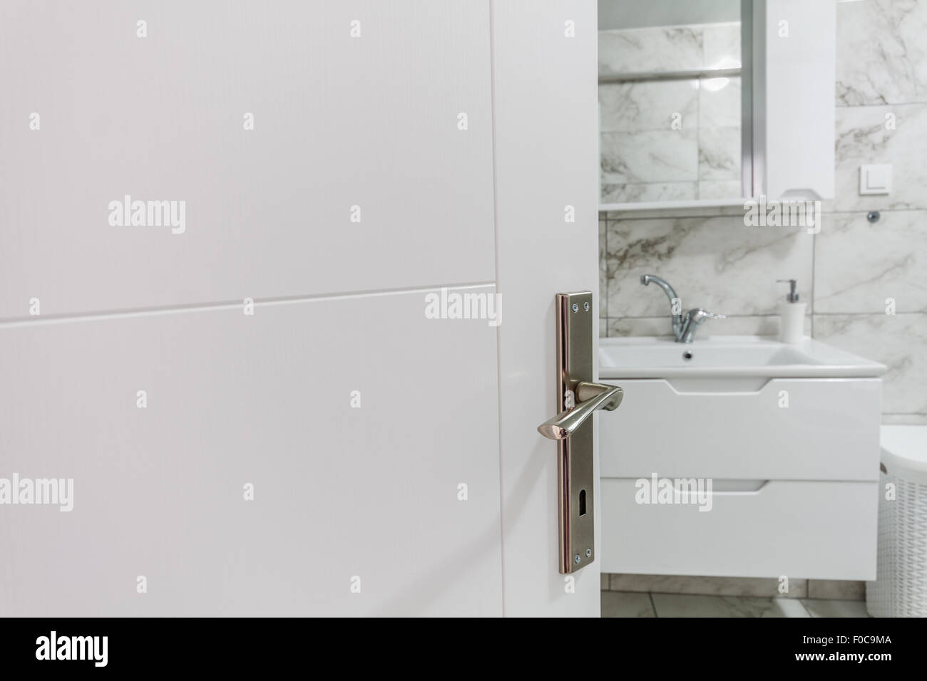 Clean, modern bathroom interior with white sink, faucet and closet ...