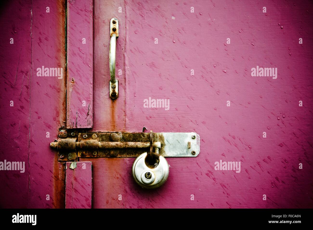 Pink wooden door with lock Stock Photo - Alamy