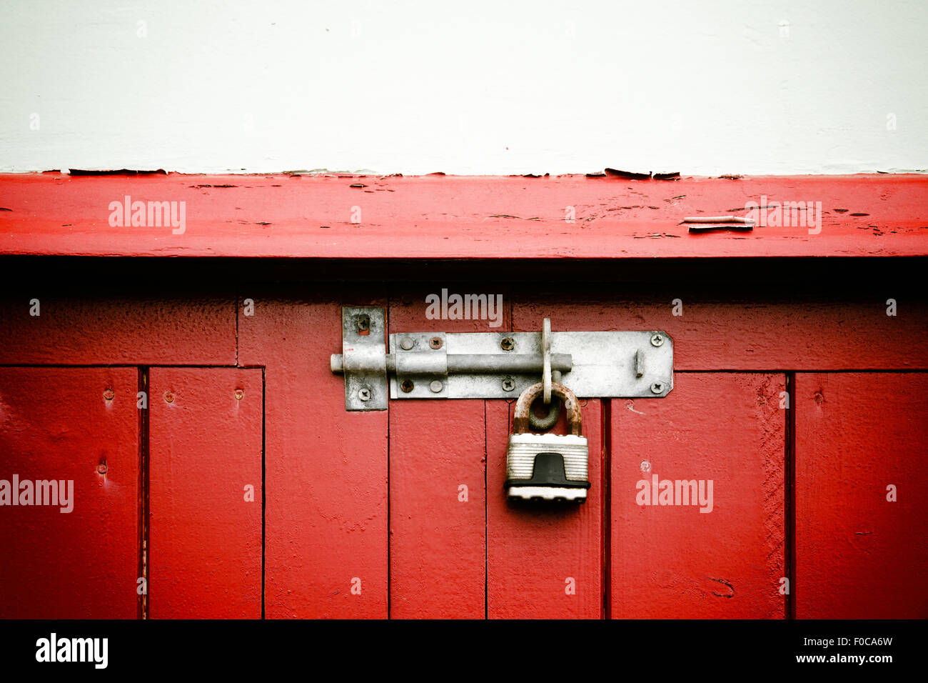 Old rusty padlock on red Stock Photo - Alamy