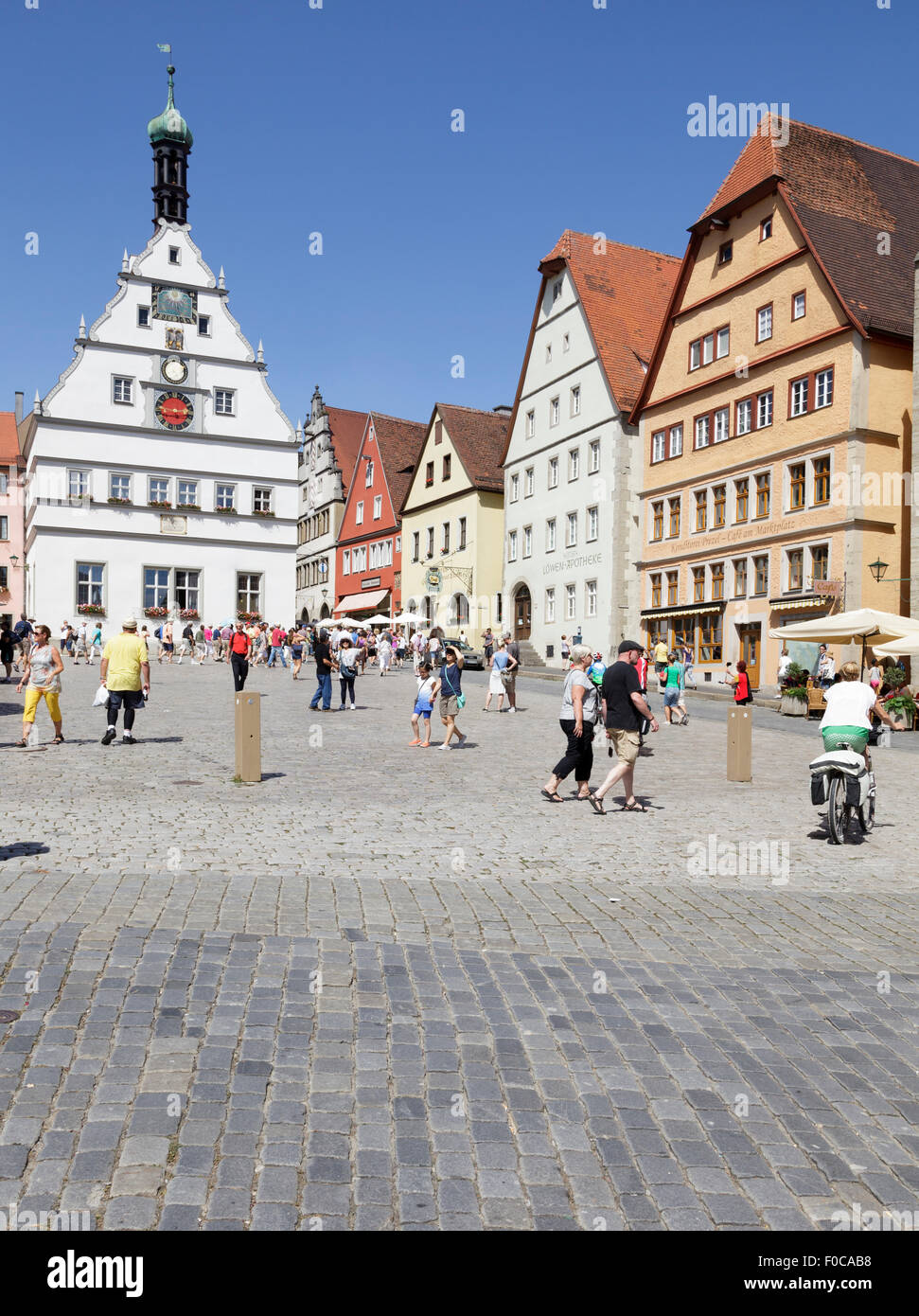 Tourists walking by typical buildings on the Marktplatz Market Square ...