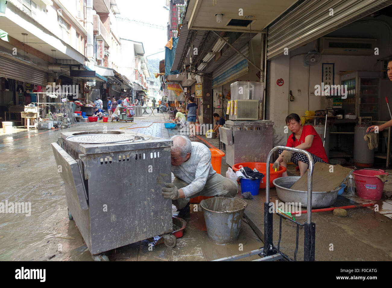 New Taipei. 12th Aug, 2015. People clean their stores after Typhoon ...
