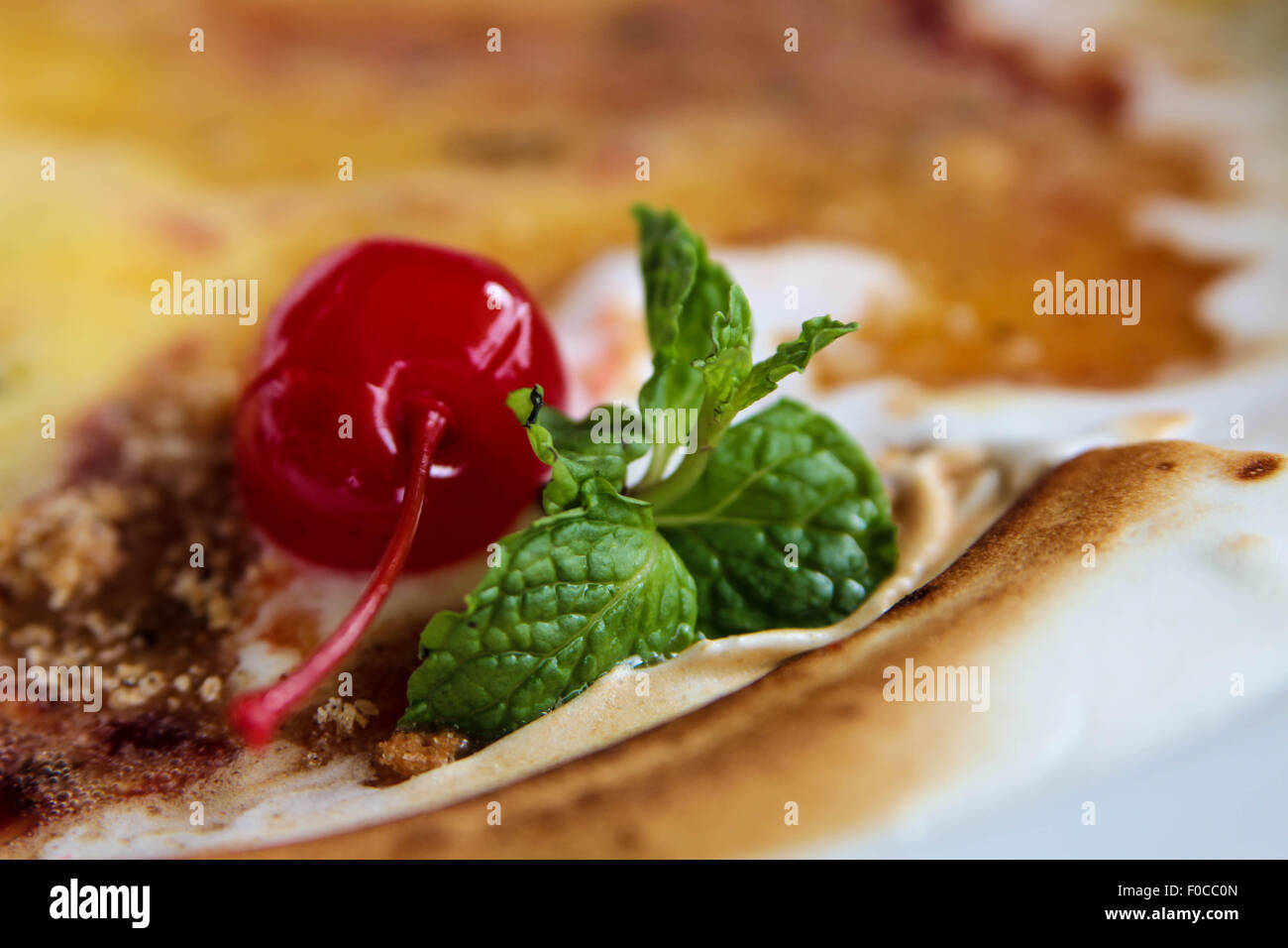 Creamy desert with cherry and mint Stock Photo - Alamy