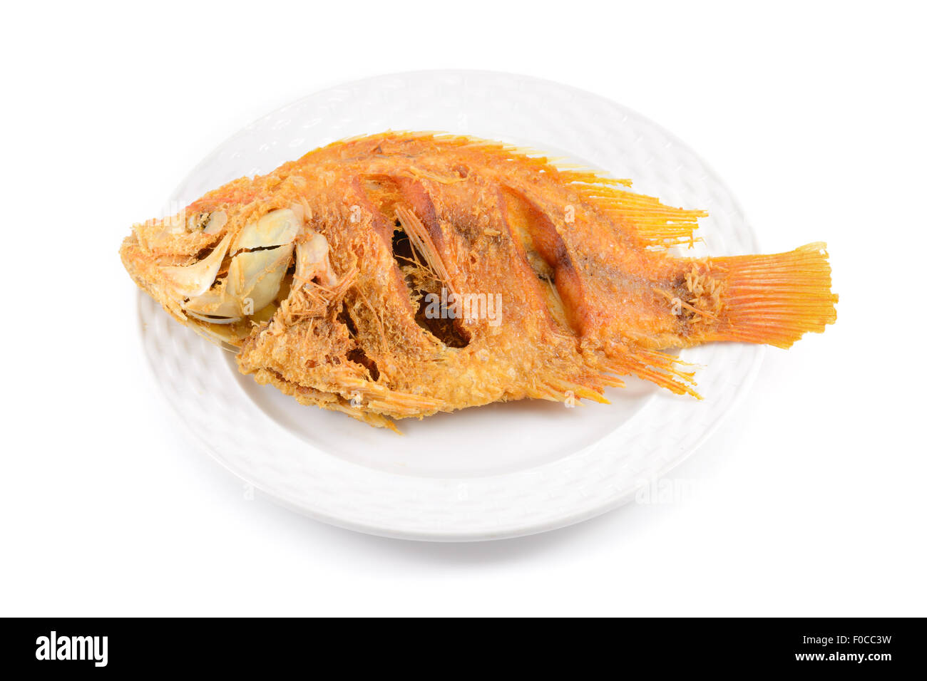 Fried fish on dish isolated on white background Stock Photo - Alamy