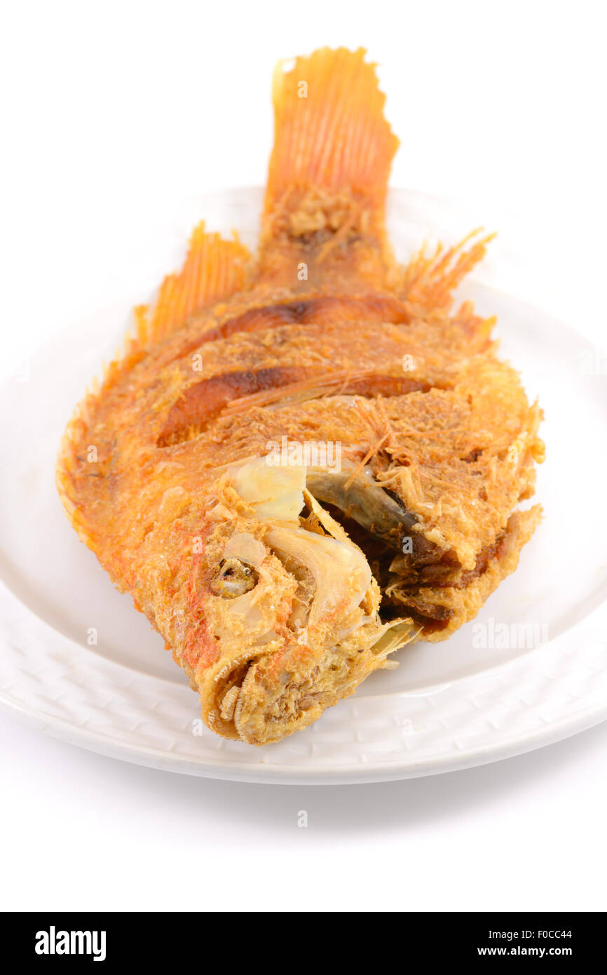 Fried fish on dish isolated on white background Stock Photo - Alamy