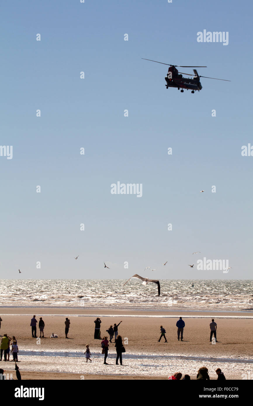 A military helicopter flying over a beach Stock Photo - Alamy