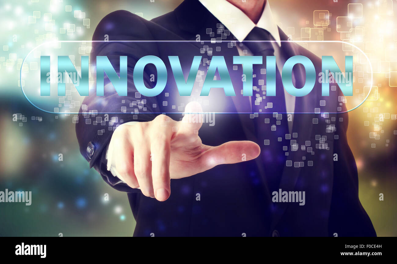 Businessman pressing INNOVATION button on touch screen Stock Photo - Alamy